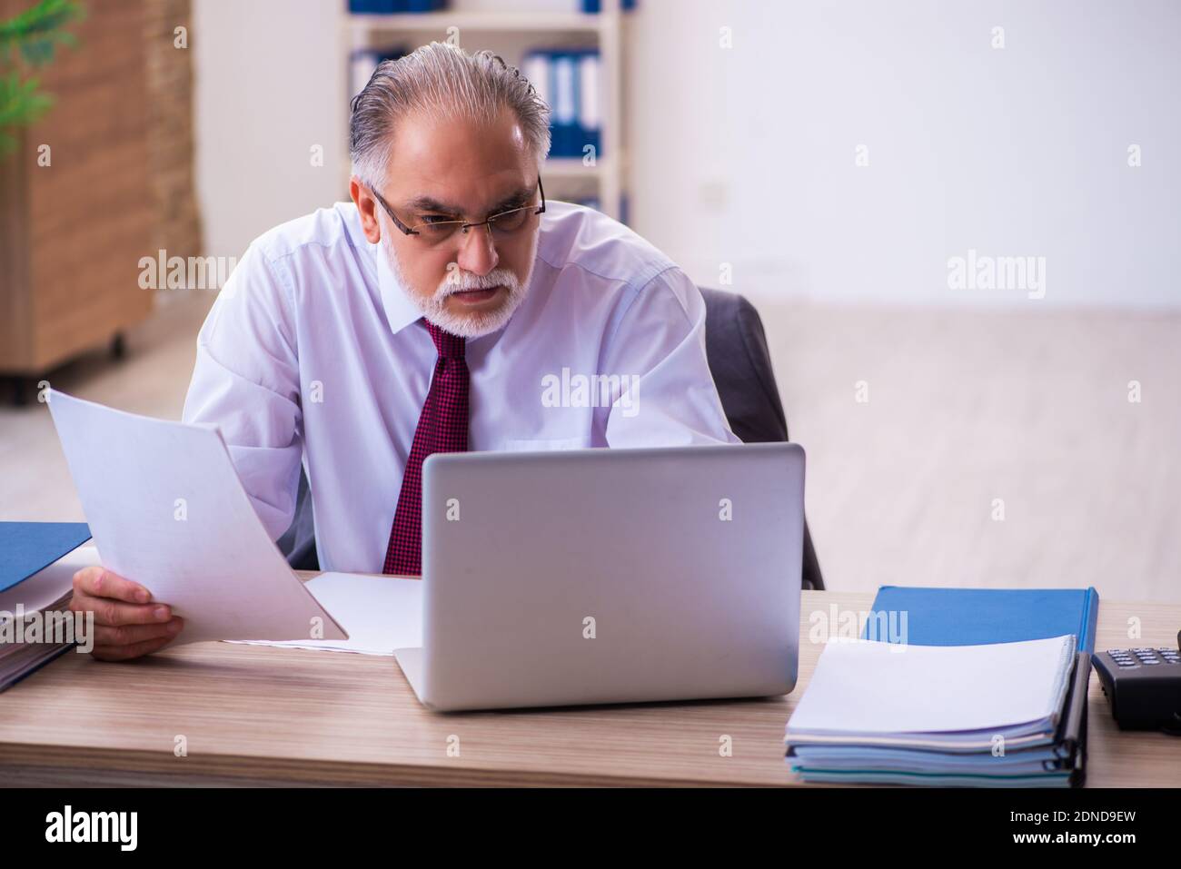 Old employee working in the office Stock Photo - Alamy