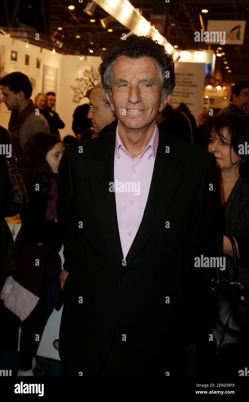 Jack Lang signs copies of his book during the 35th Salon du Livre de ...