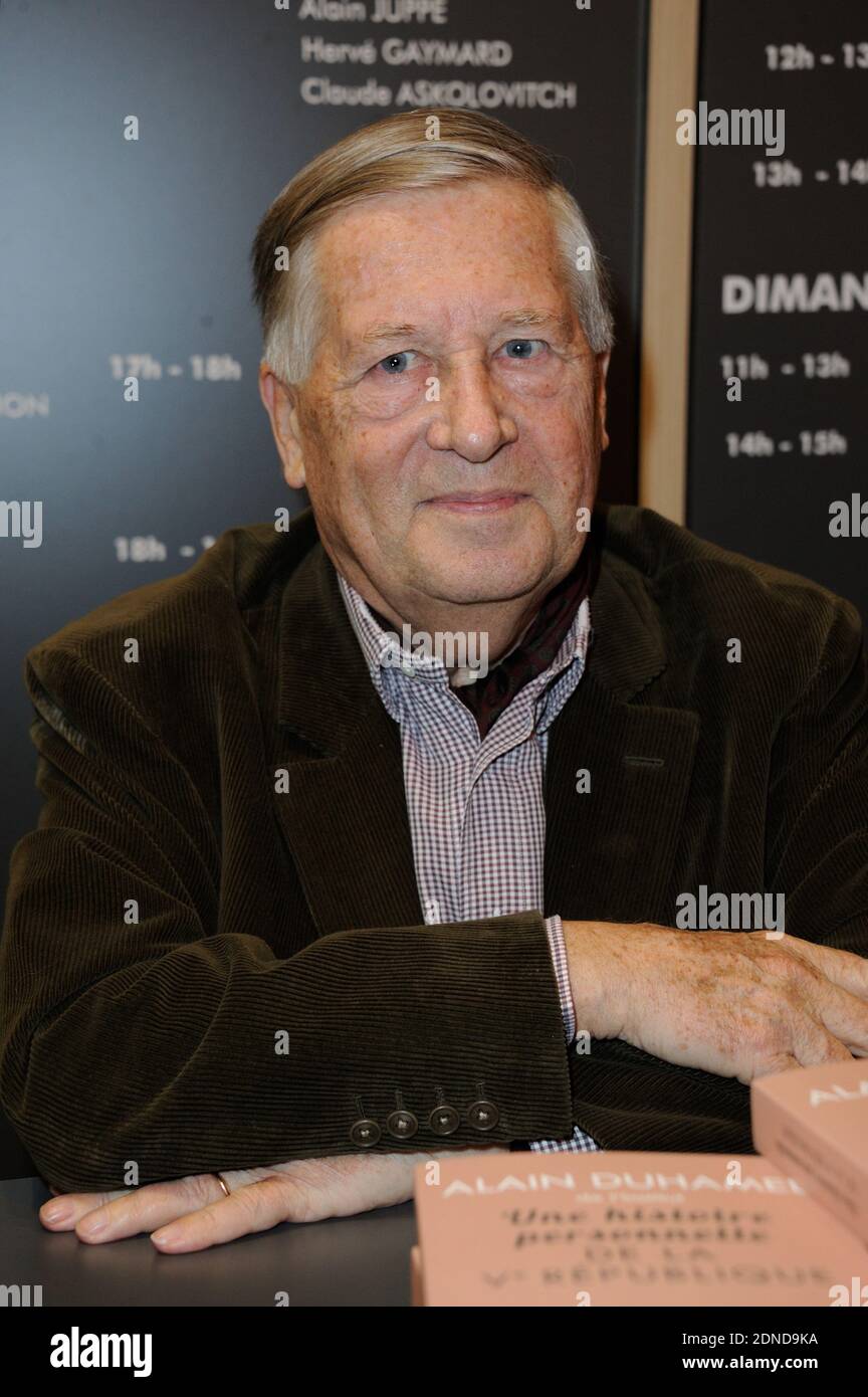 Patrice Duhamel signs copies of his book during the 35th Salon du Livre ...