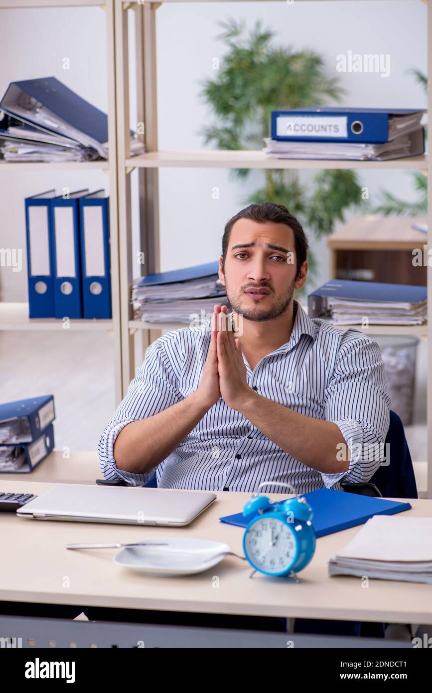 Hungry employee waiting for food in time management concept Stock Photo ...