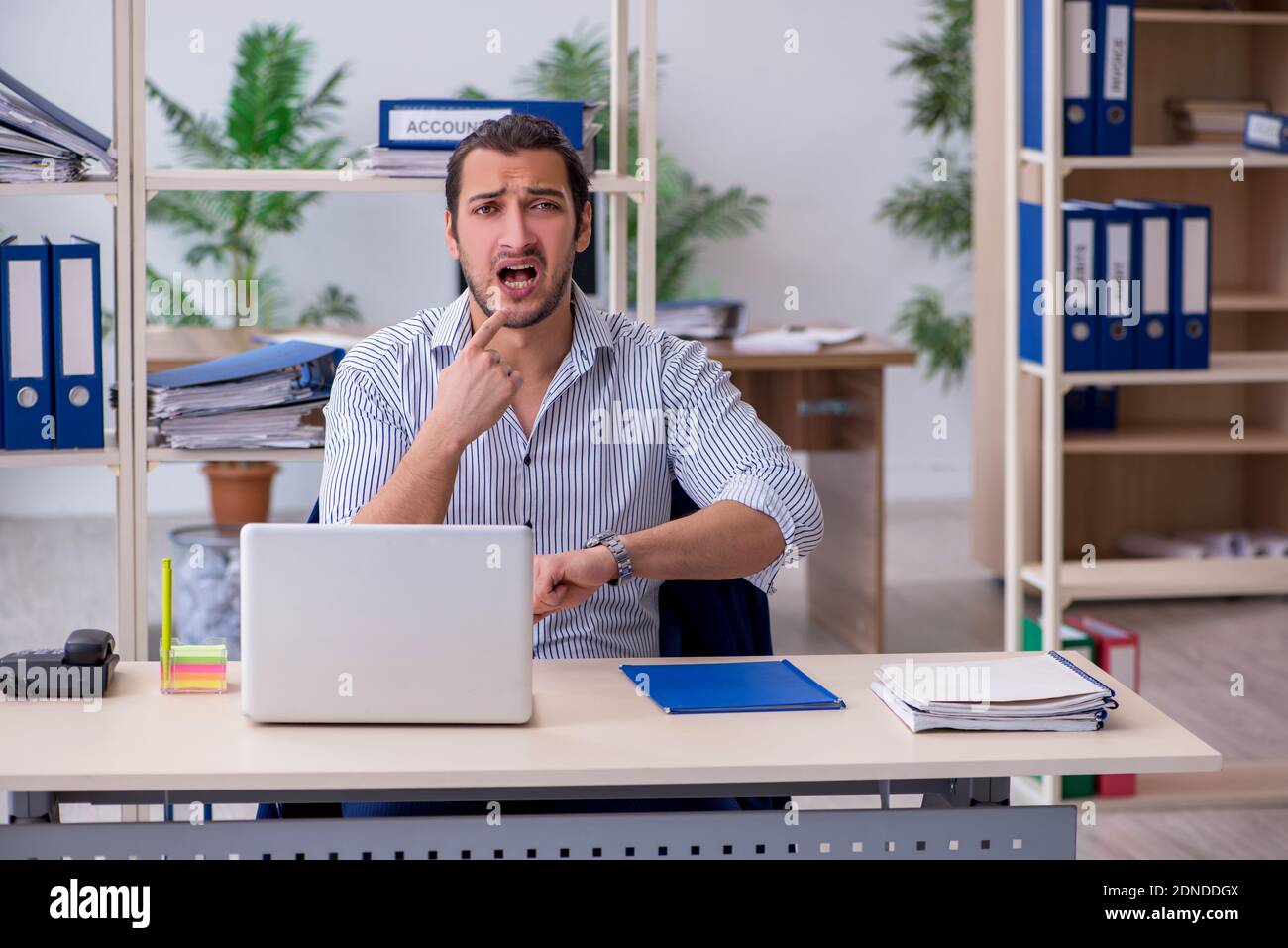 Hungry employee waiting for food in time management concept Stock Photo ...