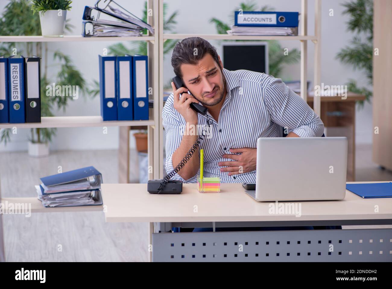 Hungry employee ordering food at workplace Stock Photo - Alamy