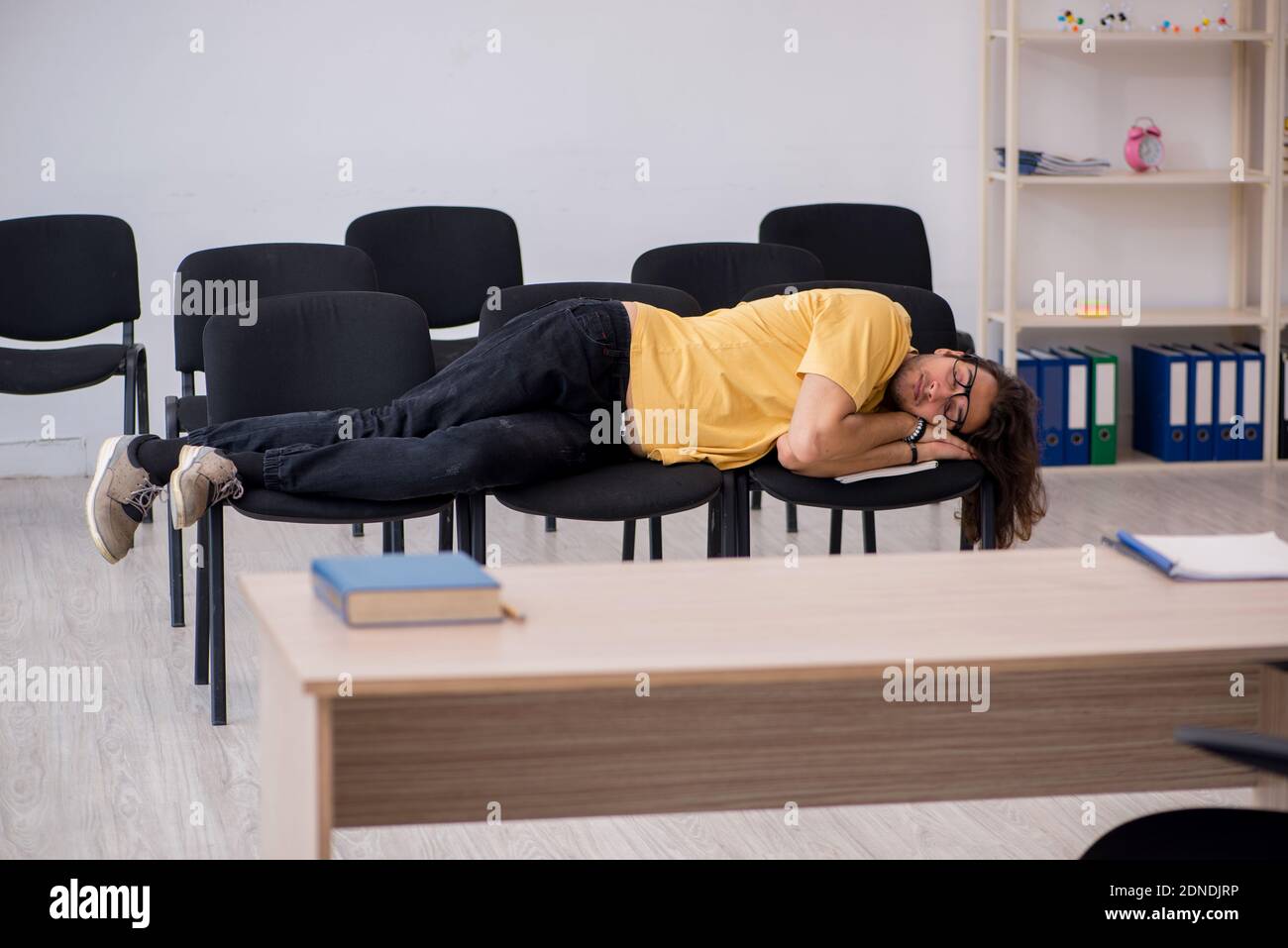 Young student waiting for teacher in the classroom Stock Photo - Alamy