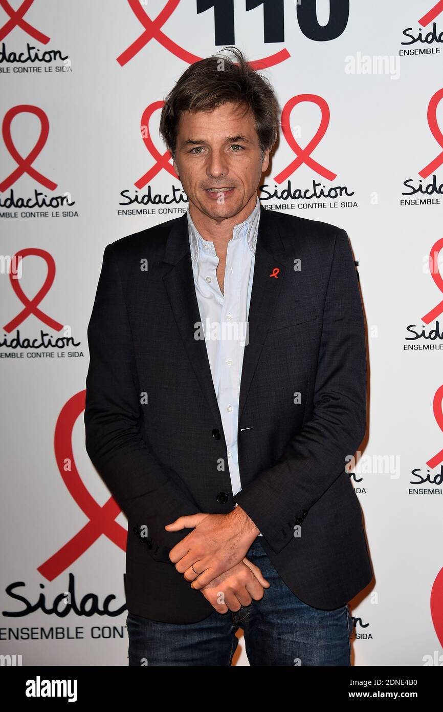 Guy Lagache posing at a photocall for the launch of the 2015 Sidaction ...