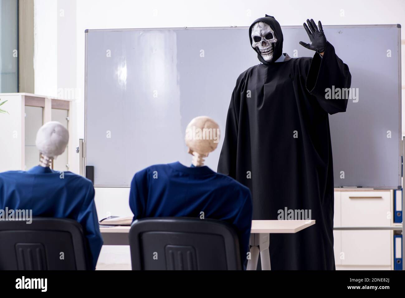 Funny business meeting with the devil and skeletons Stock Photo - Alamy