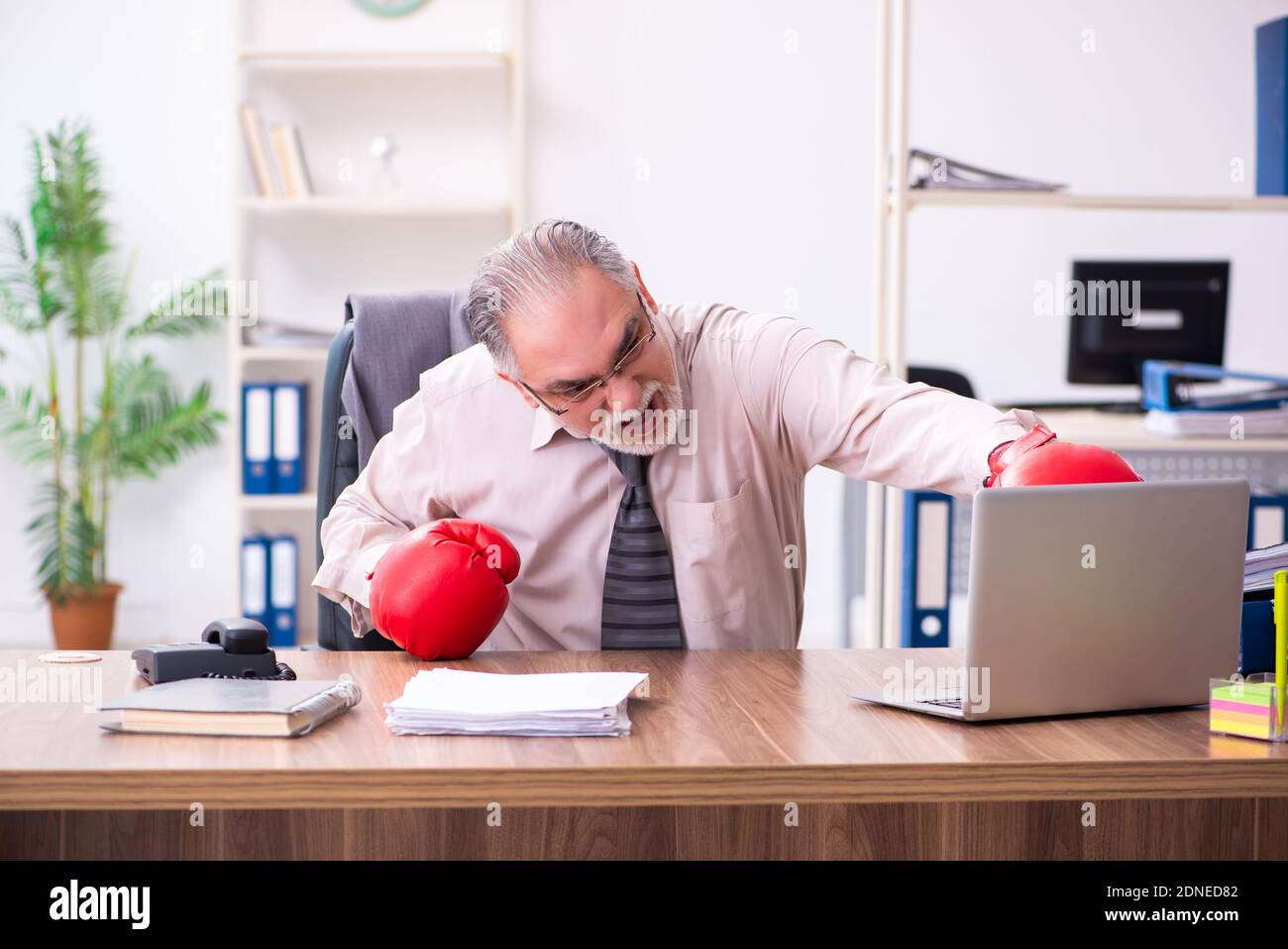 Businessman angry and furious at his workplace Stock Photo - Alamy