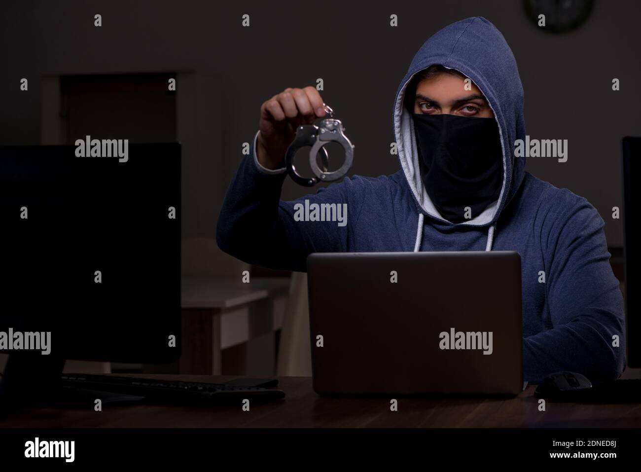 Male hacker hacking security firewall late in the office Stock Photo ...