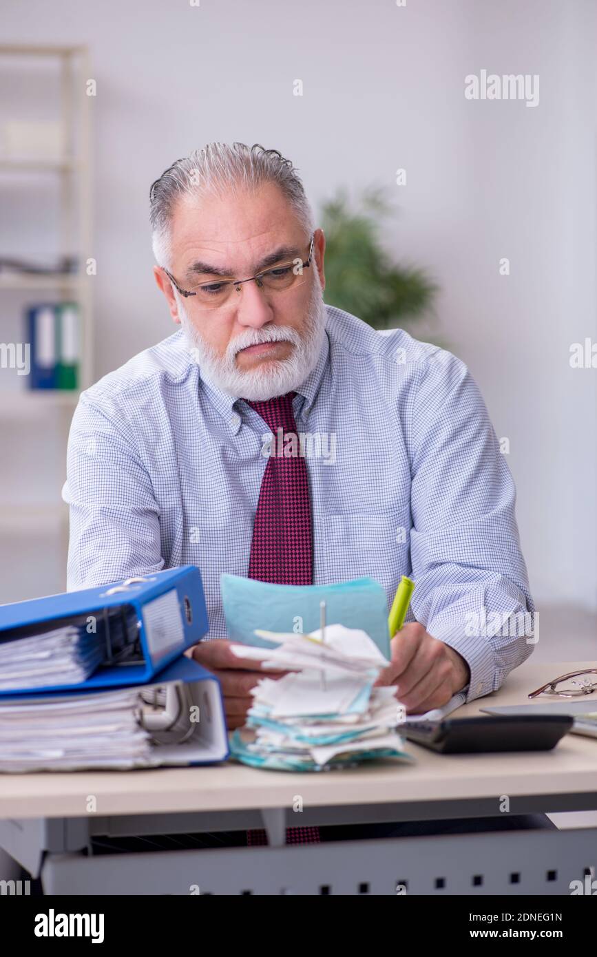 Senior accountant in budget planning concept in the office Stock Photo ...