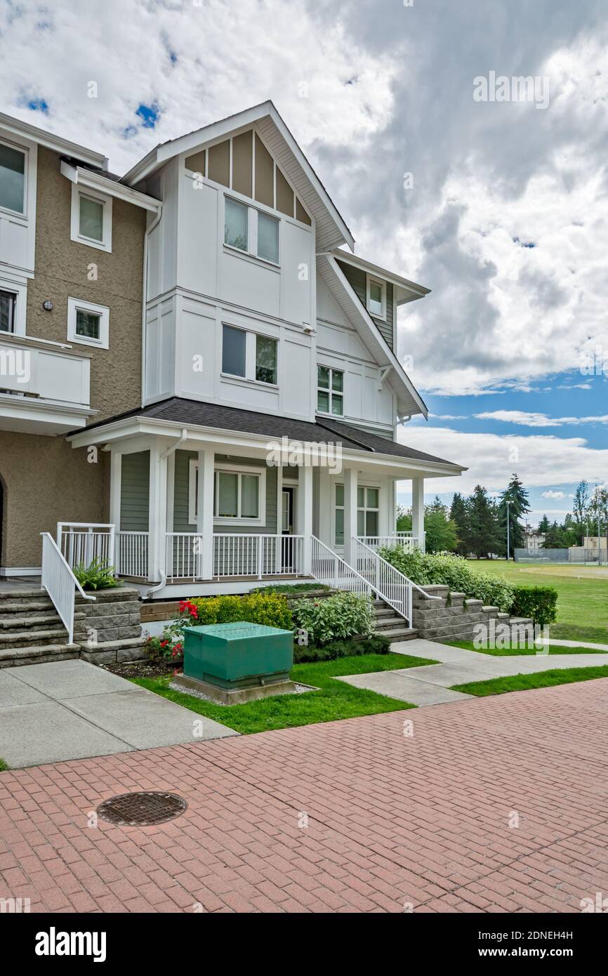 New residential low-rise building on cloudy sky background Stock Photo ...
