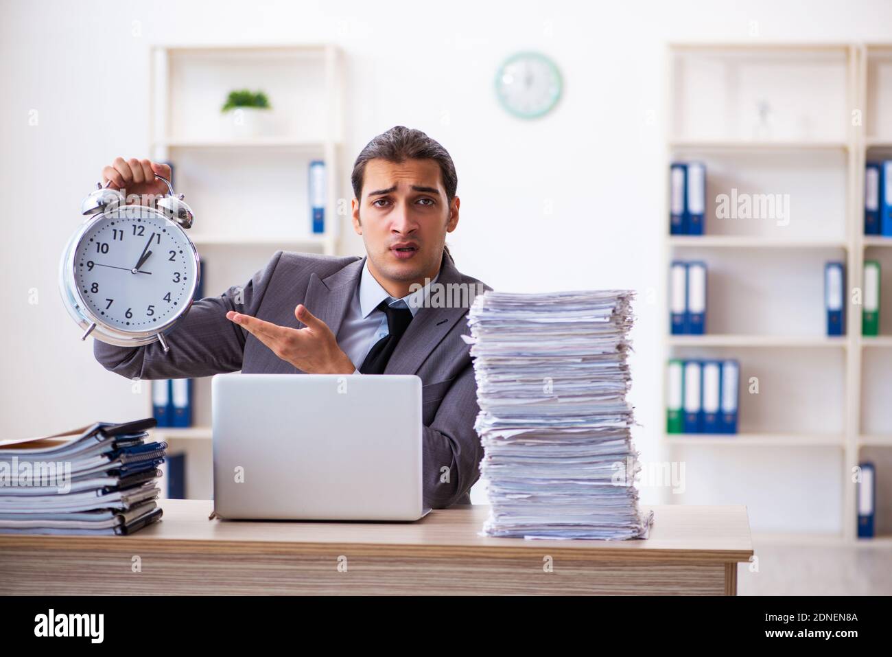 Workload employee in time management concept Stock Photo - Alamy