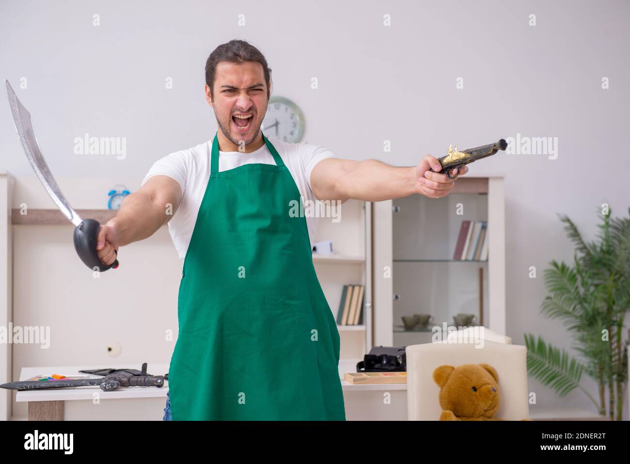 Young contractor cleaning the flat after kids' party Stock Photo - Alamy
