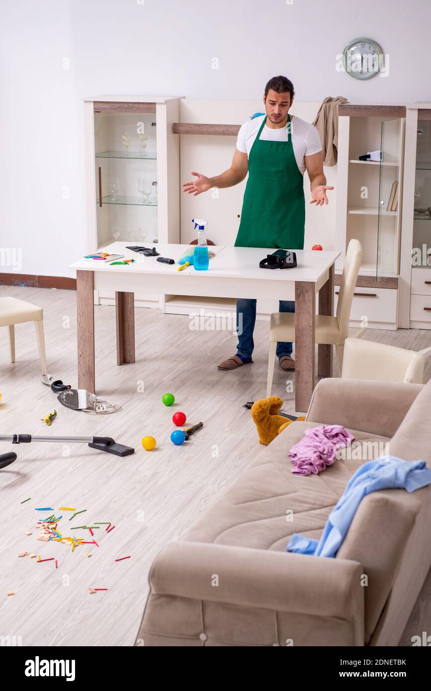 Young contractor cleaning the flat after kids' party Stock Photo - Alamy