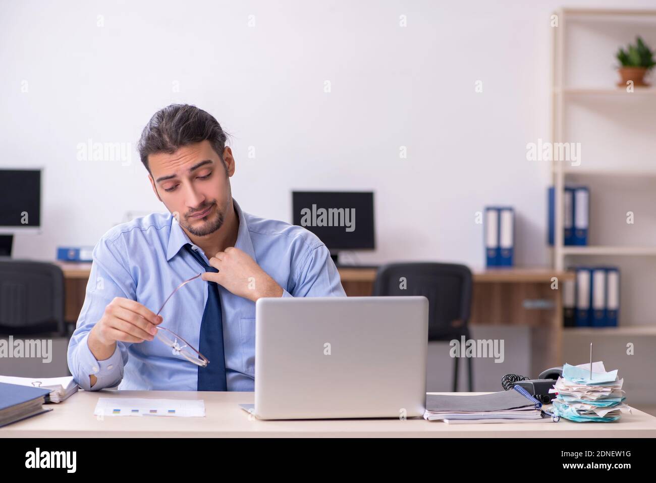 Sick male employee suffering at the workplace Stock Photo - Alamy