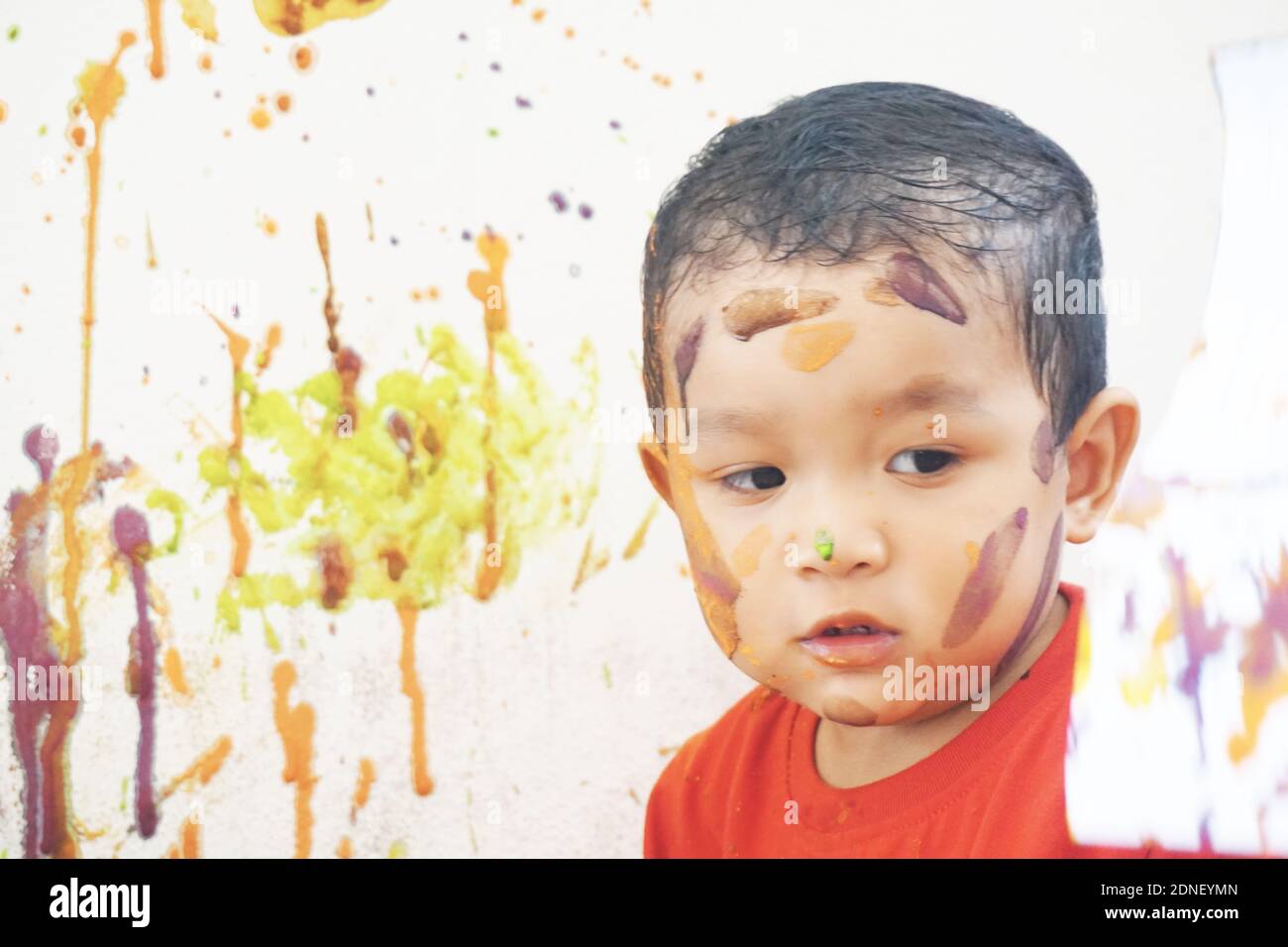 Cute Boy With Messy Face Looking Away Against Wall Stock Photo - Alamy