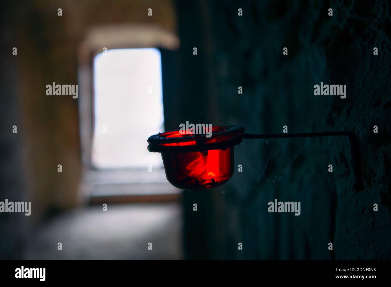 candle in dim light and daylight in opened door Stock Photo - Alamy