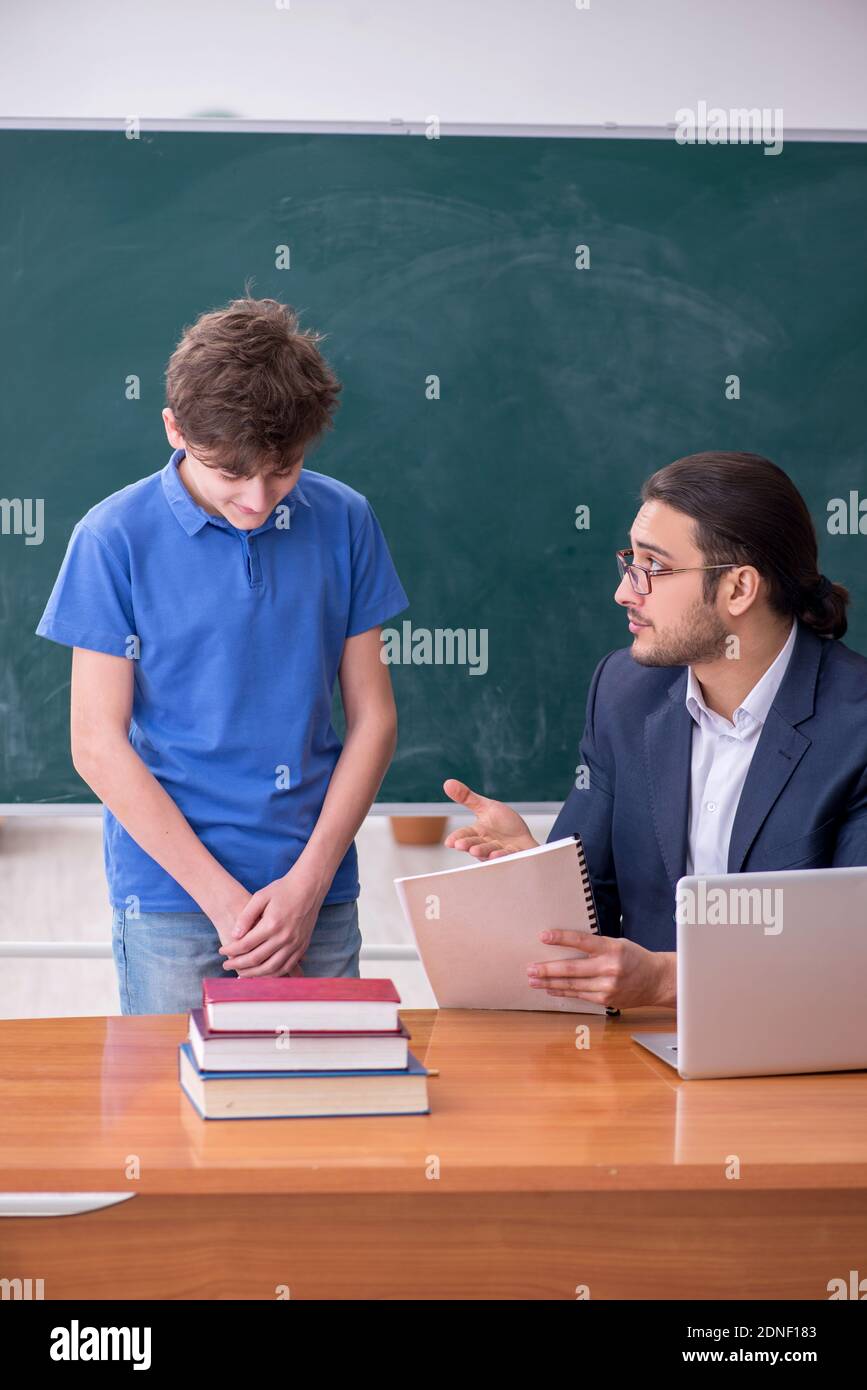 Male teacher and schoolboy in the classroom Stock Photo - Alamy