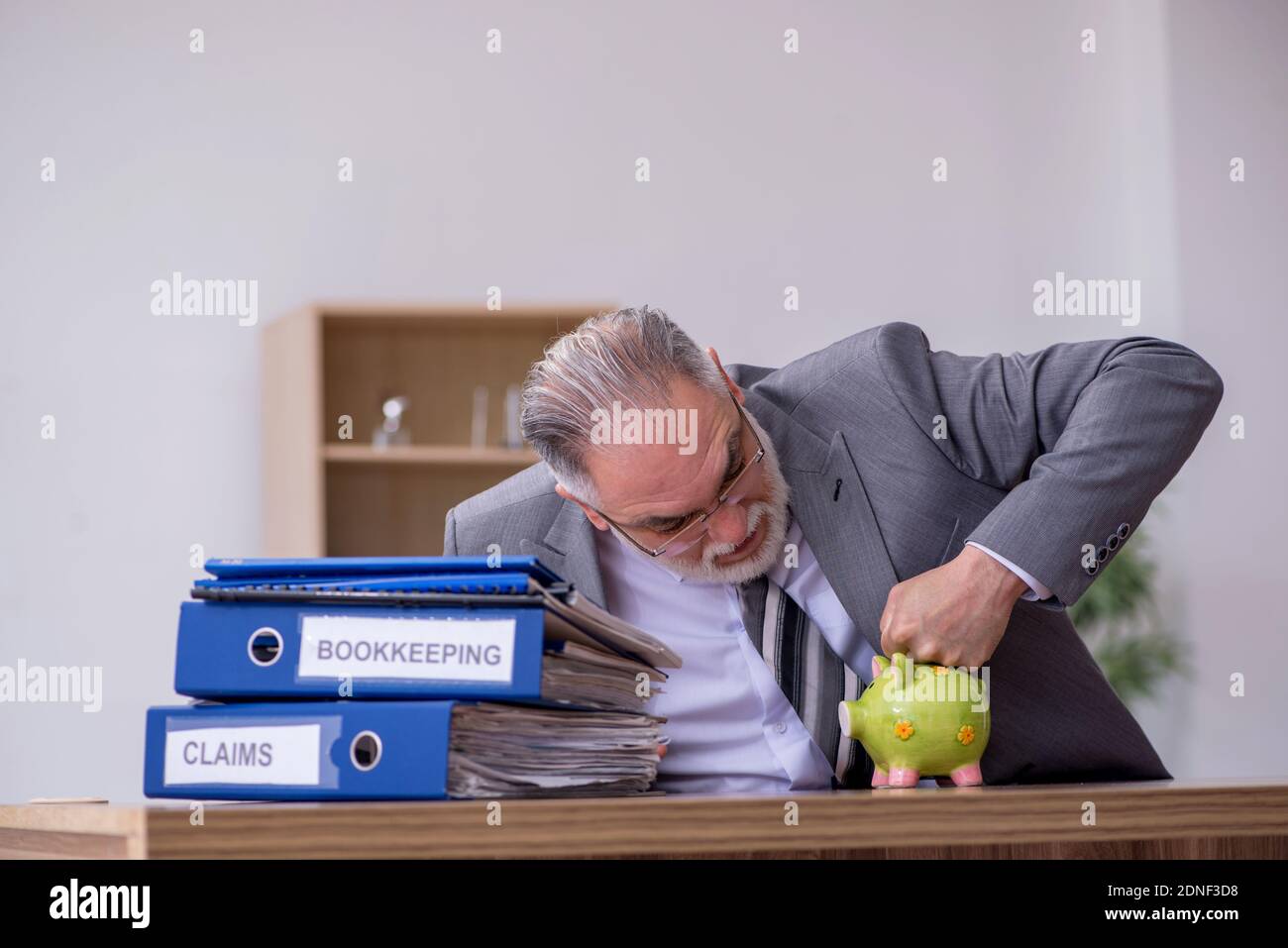 Old aggressive bookkeeper in budget planning concept Stock Photo - Alamy