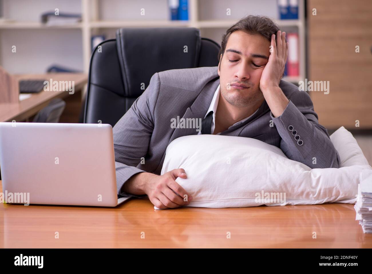 Young employee sleeping at workplace Stock Photo - Alamy