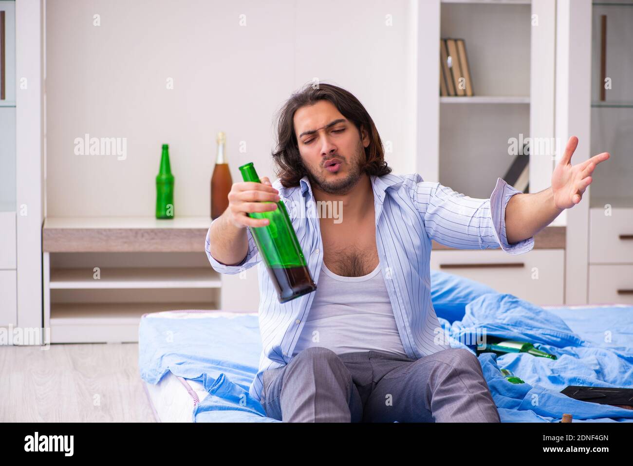 Male alcoholic in the bedroom Stock Photo - Alamy