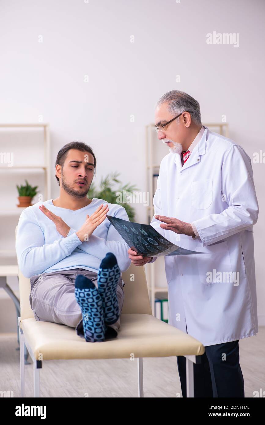 Sick man visiting old doctor radiologist Stock Photo - Alamy