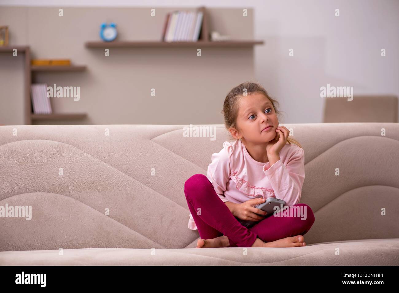 Little girl staying alone at home Stock Photo - Alamy