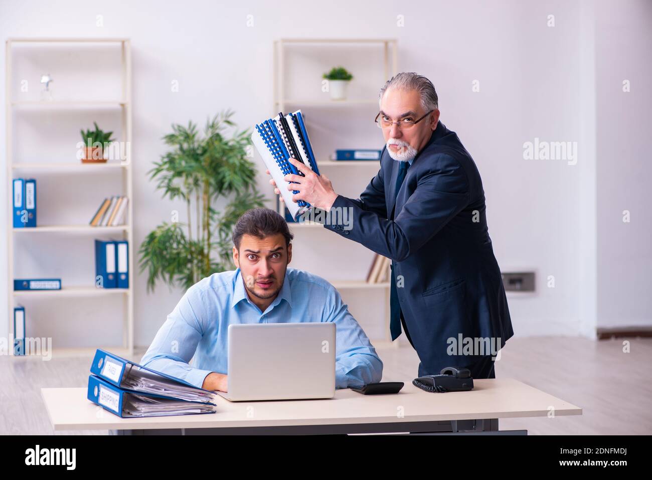 Old boss and young assistant in the office Stock Photo - Alamy