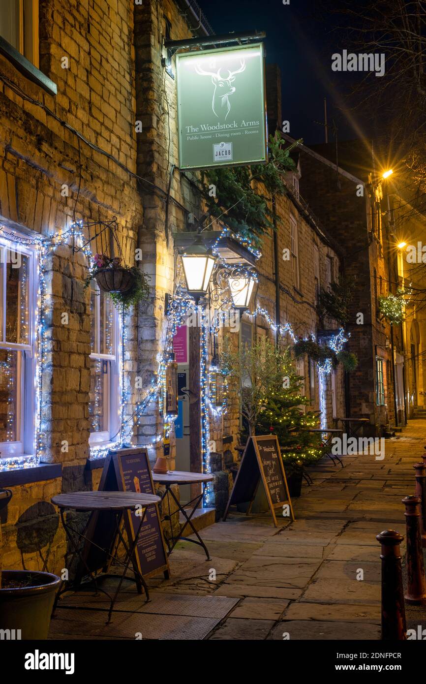 Christmas trees and decorations outside the Woodstock arms pub at night ...