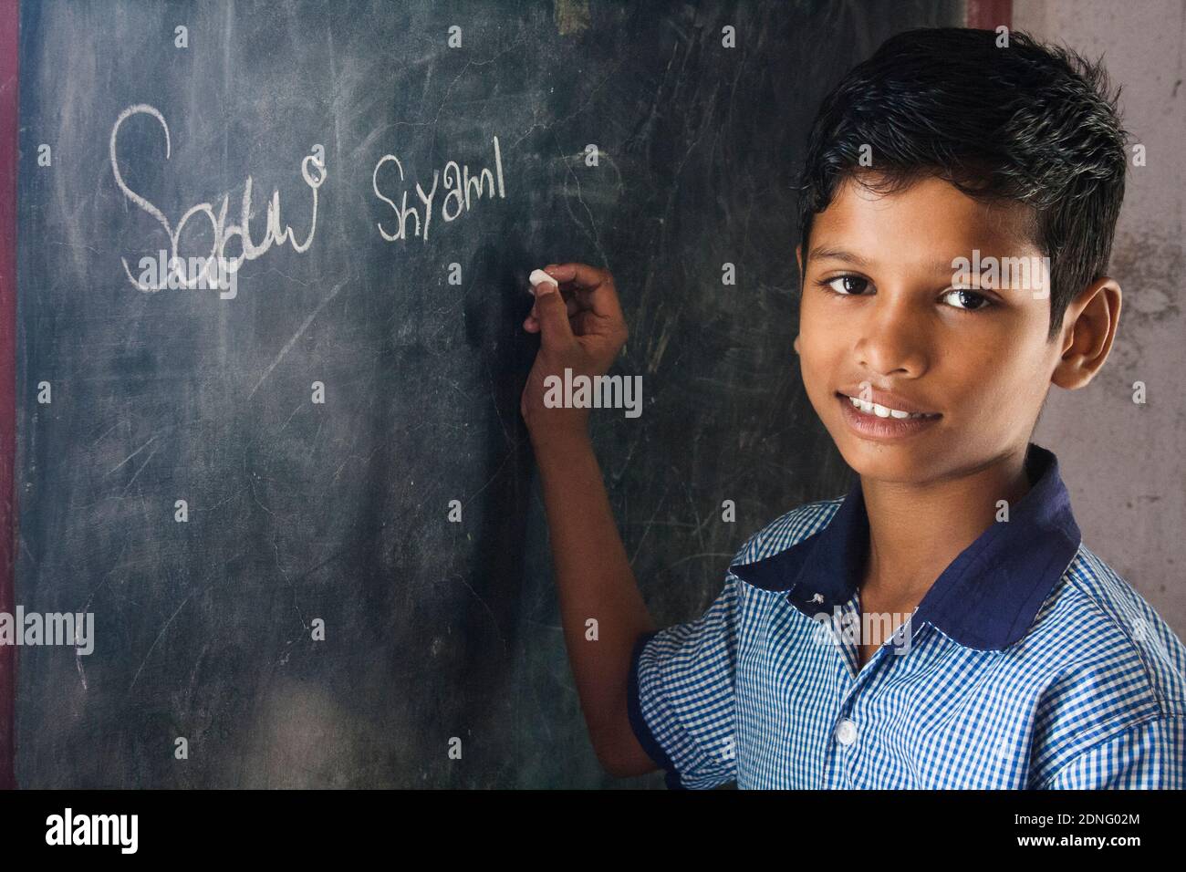 Asian boy writing on blackboard hi-res stock photography and images - Alamy