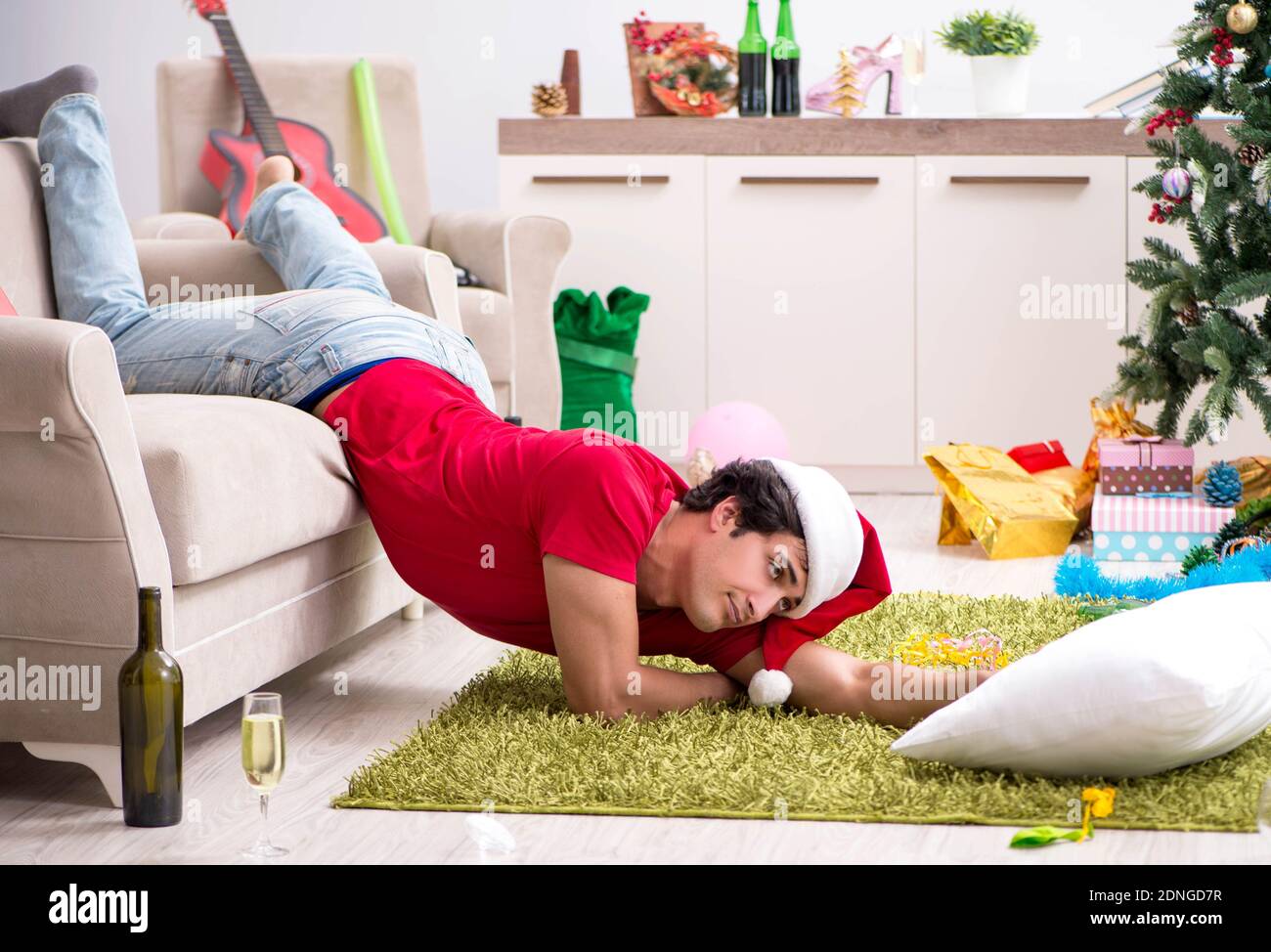The young man drunk at home after christmas party Stock Photo - Alamy