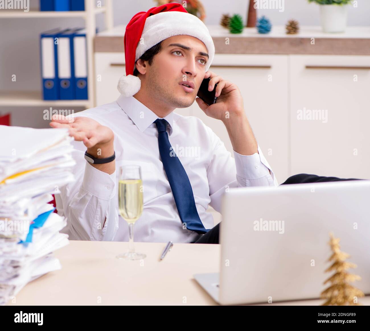 The young worker working in office on christmas shift Stock Photo - Alamy