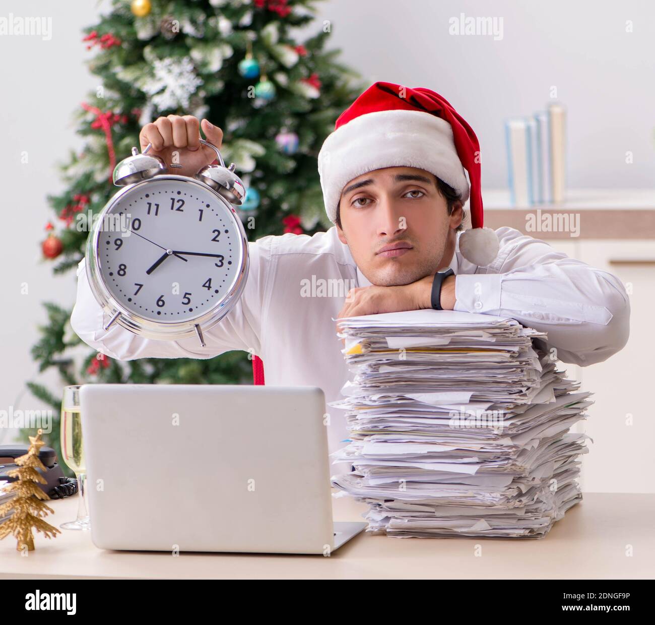 The young worker working in office on christmas shift Stock Photo - Alamy