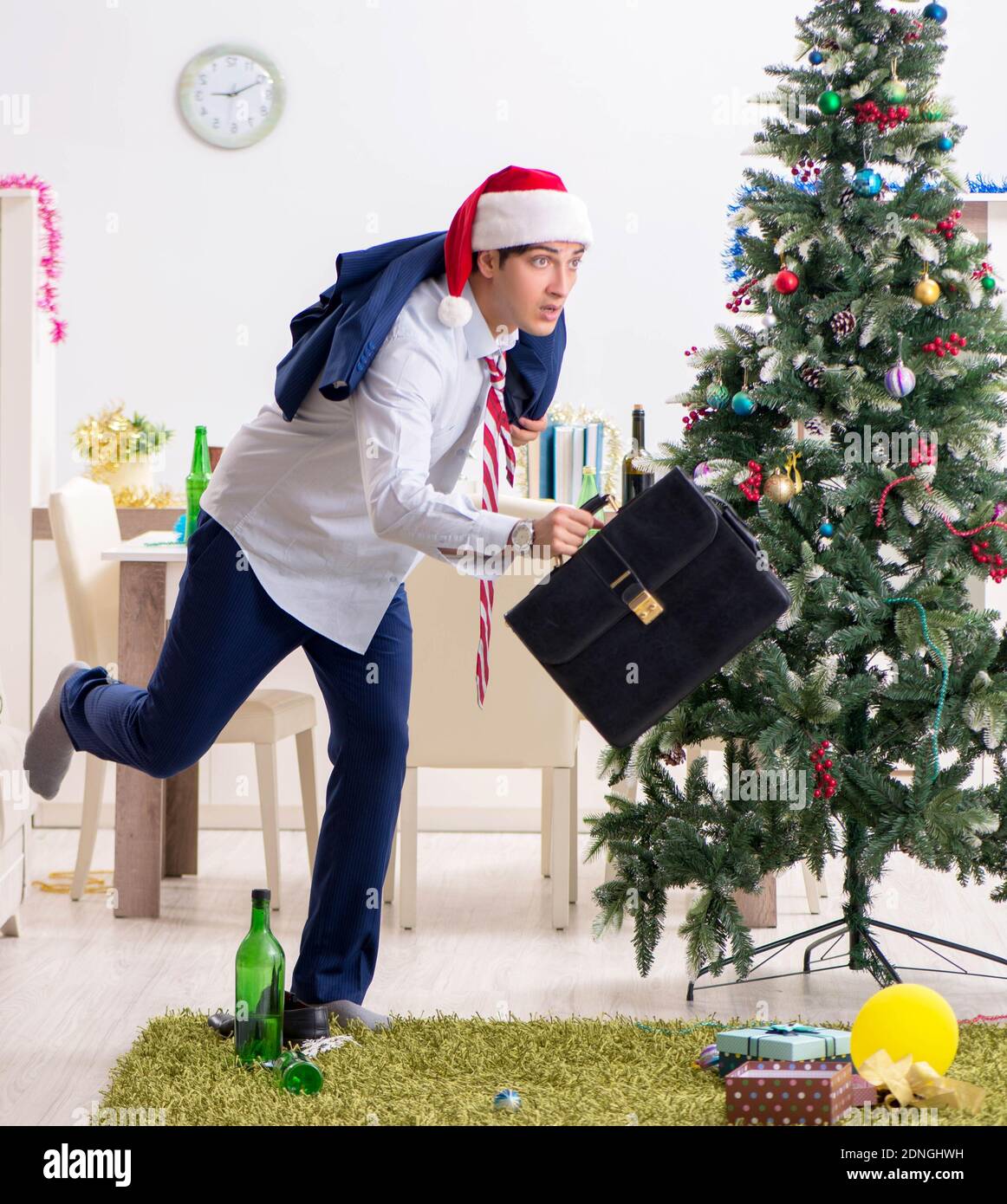 The young handsome employee celebrating christmas at workplace Stock ...