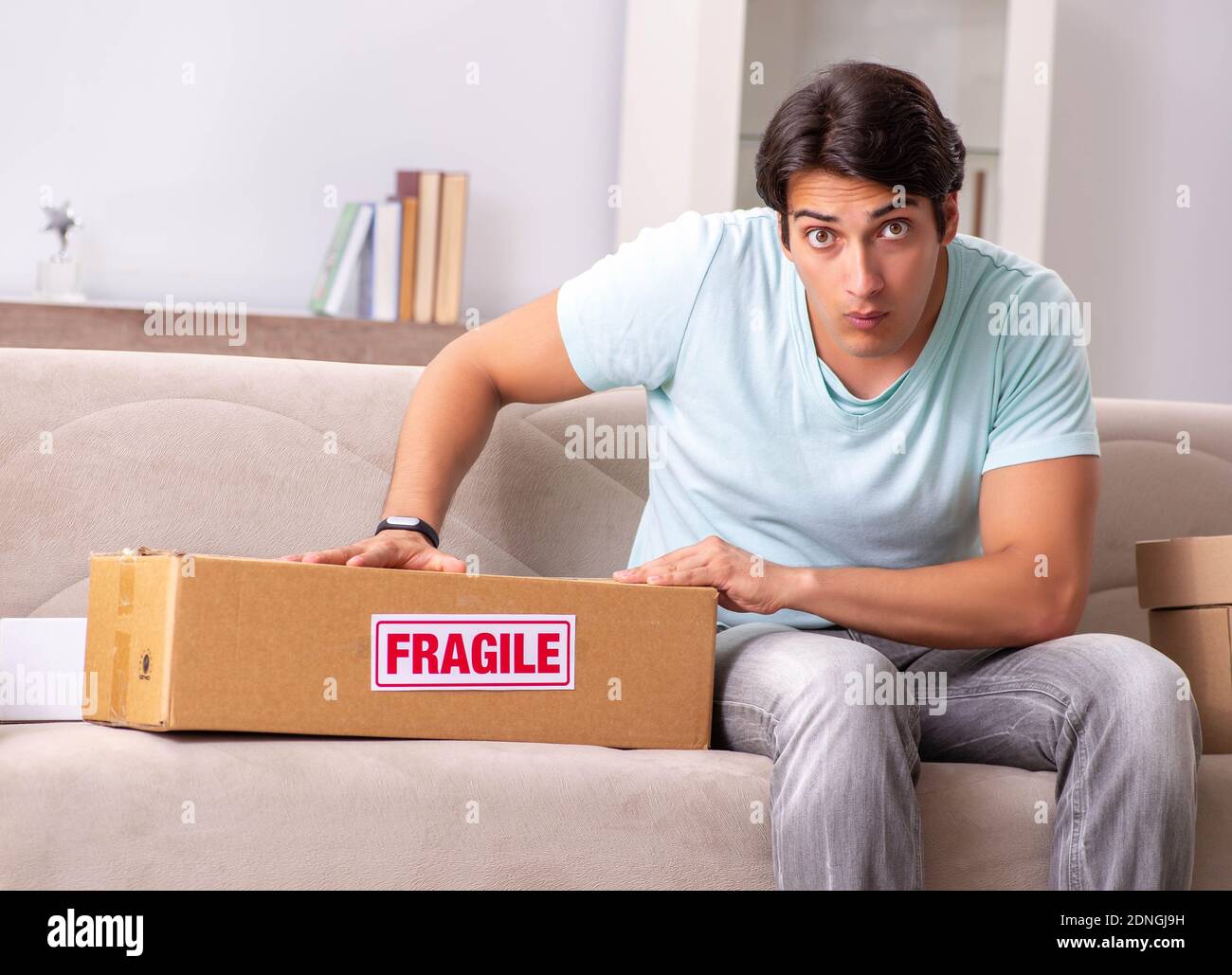 The man opening fragile parcel ordered from internet Stock Photo - Alamy