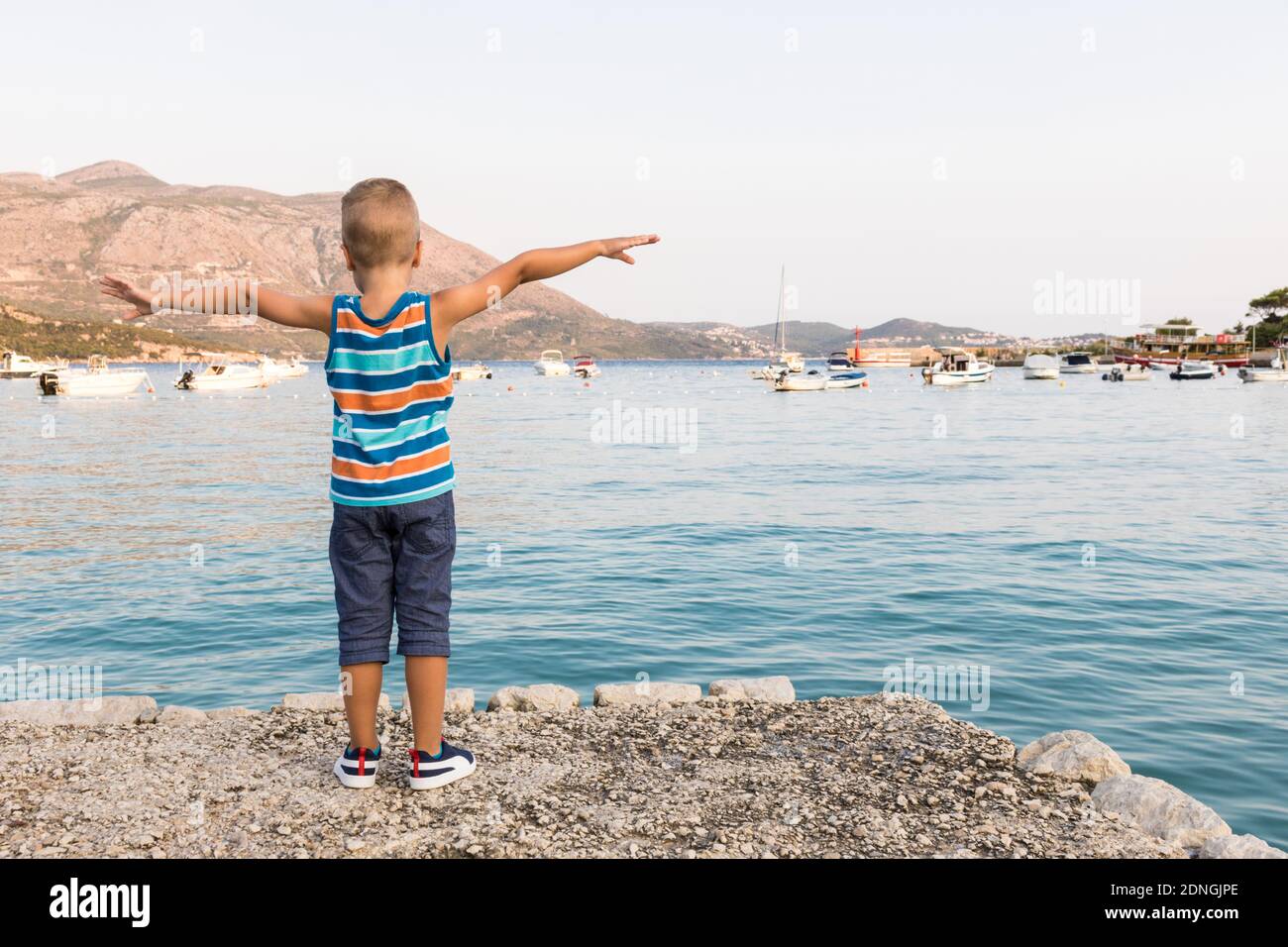 Boy shorts arms outstretched hi-res stock photography and images - Alamy