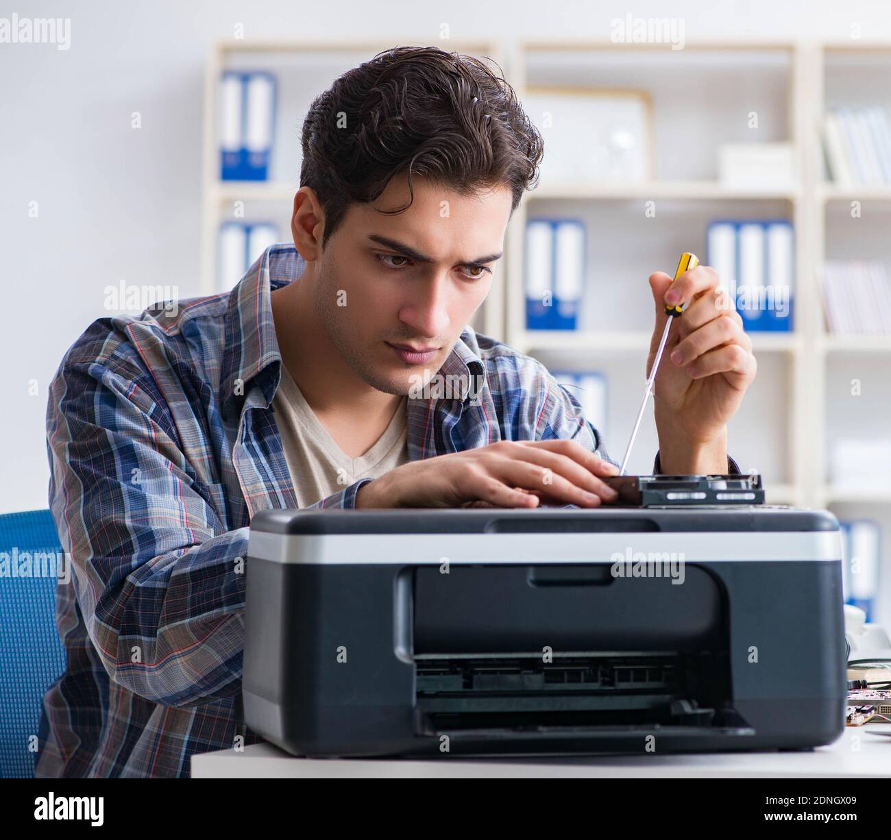 The hardware repairman repairing broken printer fax machine Stock Photo ...