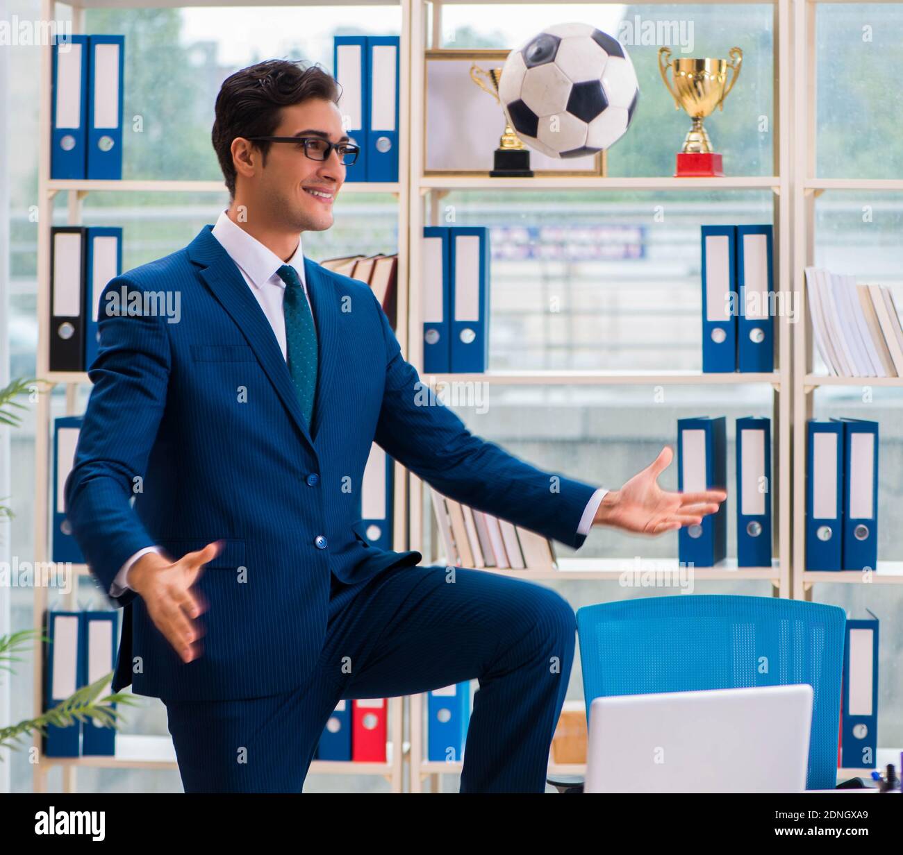 The businessman playing football in the office Stock Photo - Alamy