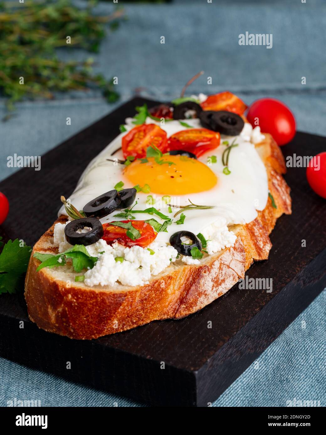 Toasted bread toast with fried eggs with yellow yolk and tomatoes ...