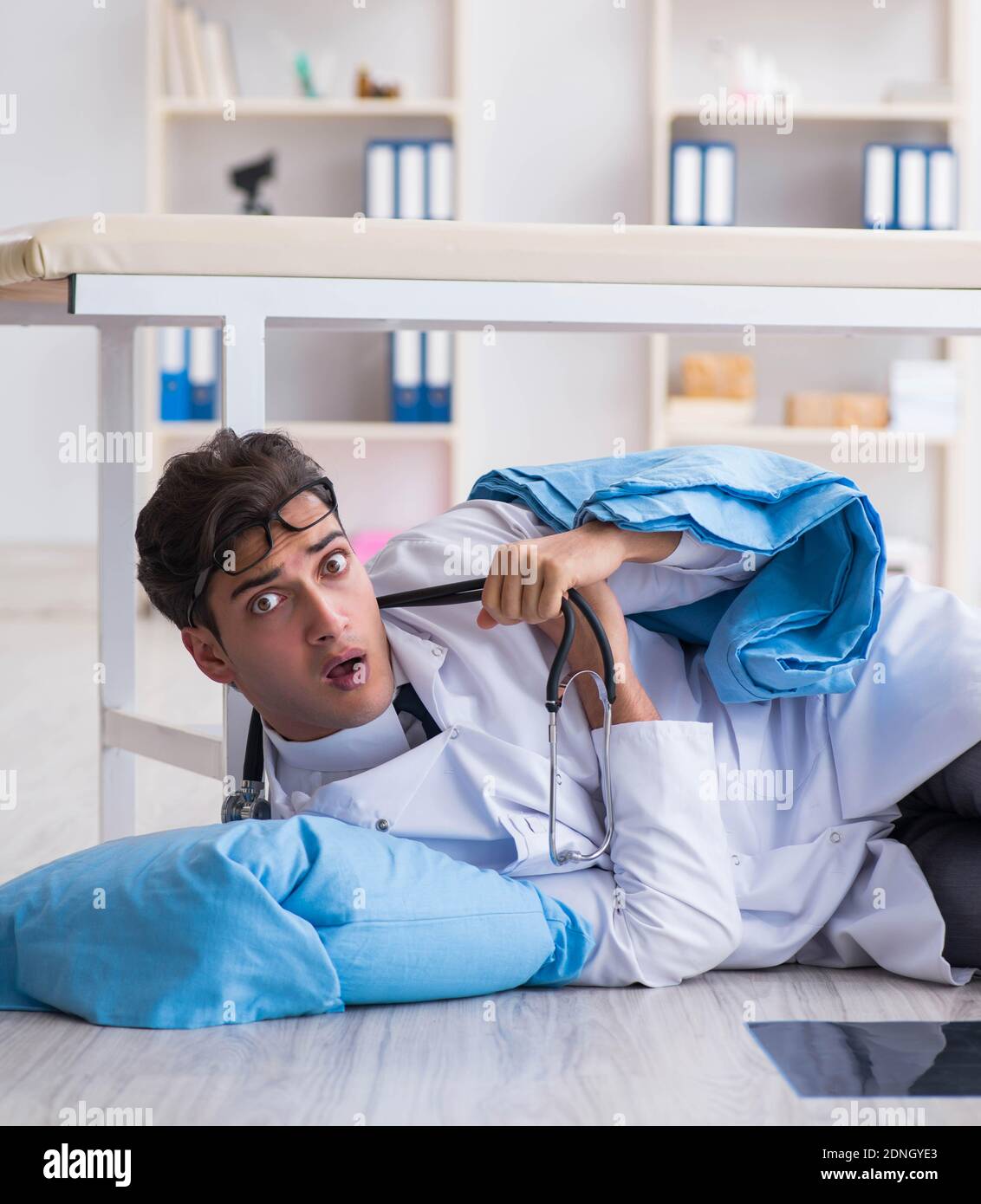 The doctor sleeping on floor after long night shift Stock Photo - Alamy