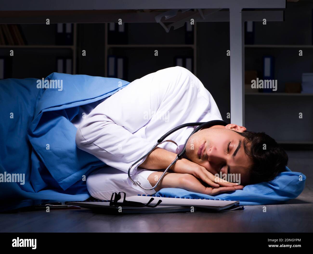 The doctor working night shift in hospital after long hours Stock Photo ...