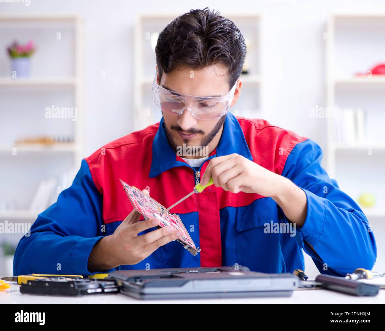 Repairman working in technical support fixing computer laptop ...