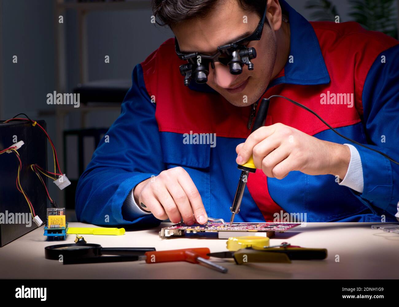 The computer specialist repairing pc late at night Stock Photo - Alamy