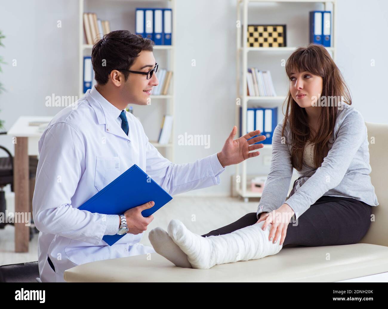 The doctor examining patient with broken leg Stock Photo - Alamy