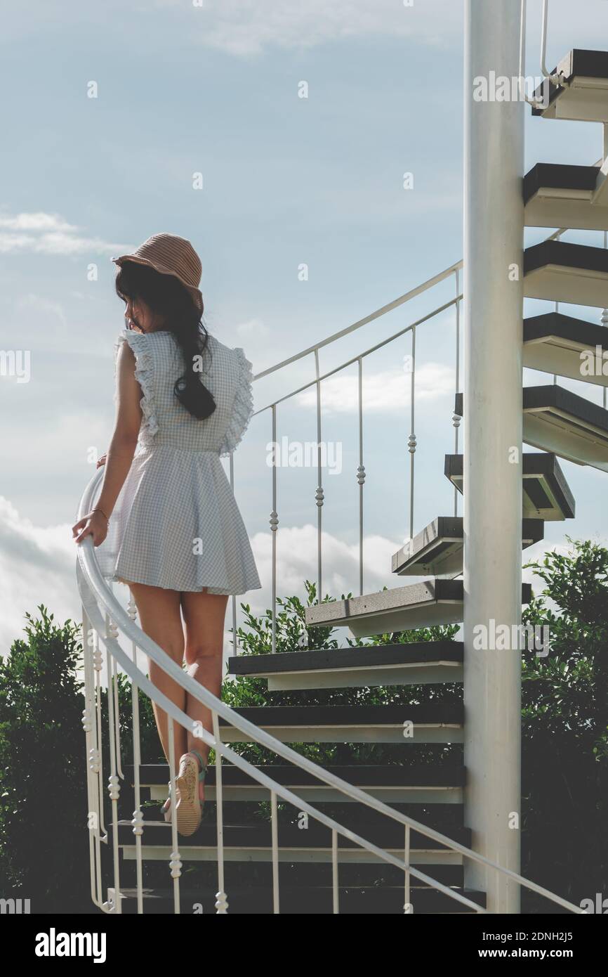 Rear View Full Length Of Woman Moving Up On Steps Stock Photo - Alamy