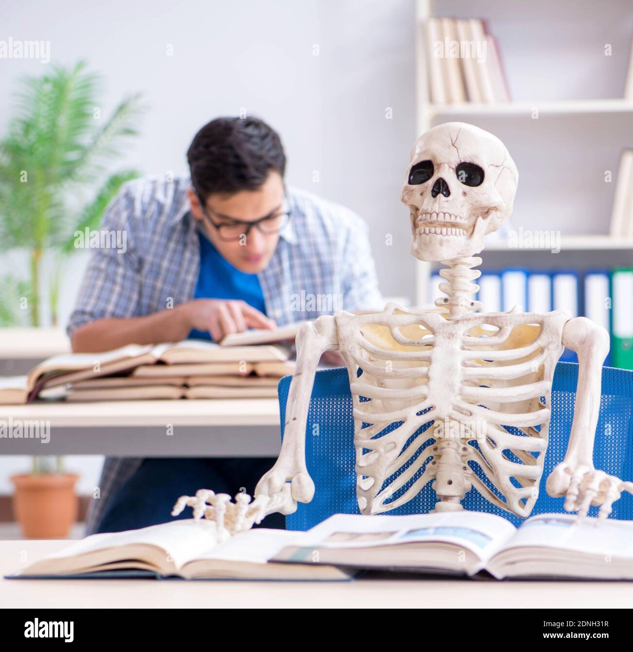 The student skeleton listening to lecture in classroom Stock Photo - Alamy