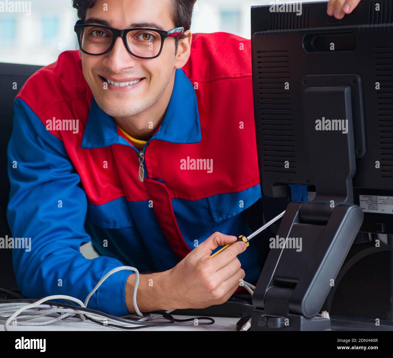 The computer repairman working on repairing computer in it workshop ...