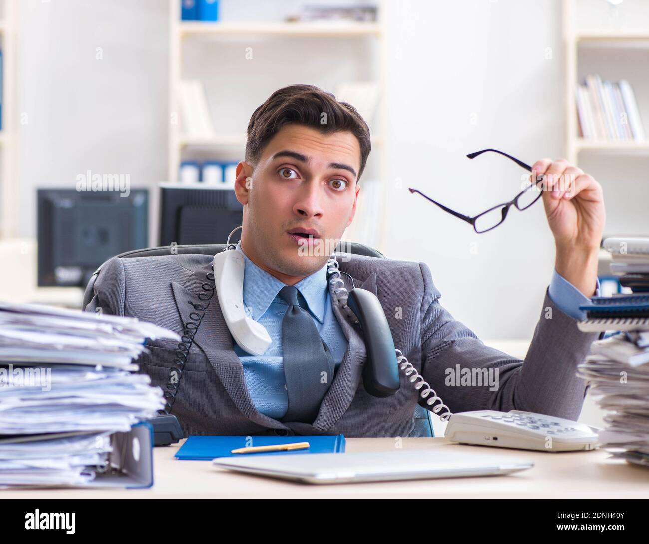 The desperate sad employee tired at his desk in call center Stock Photo ...