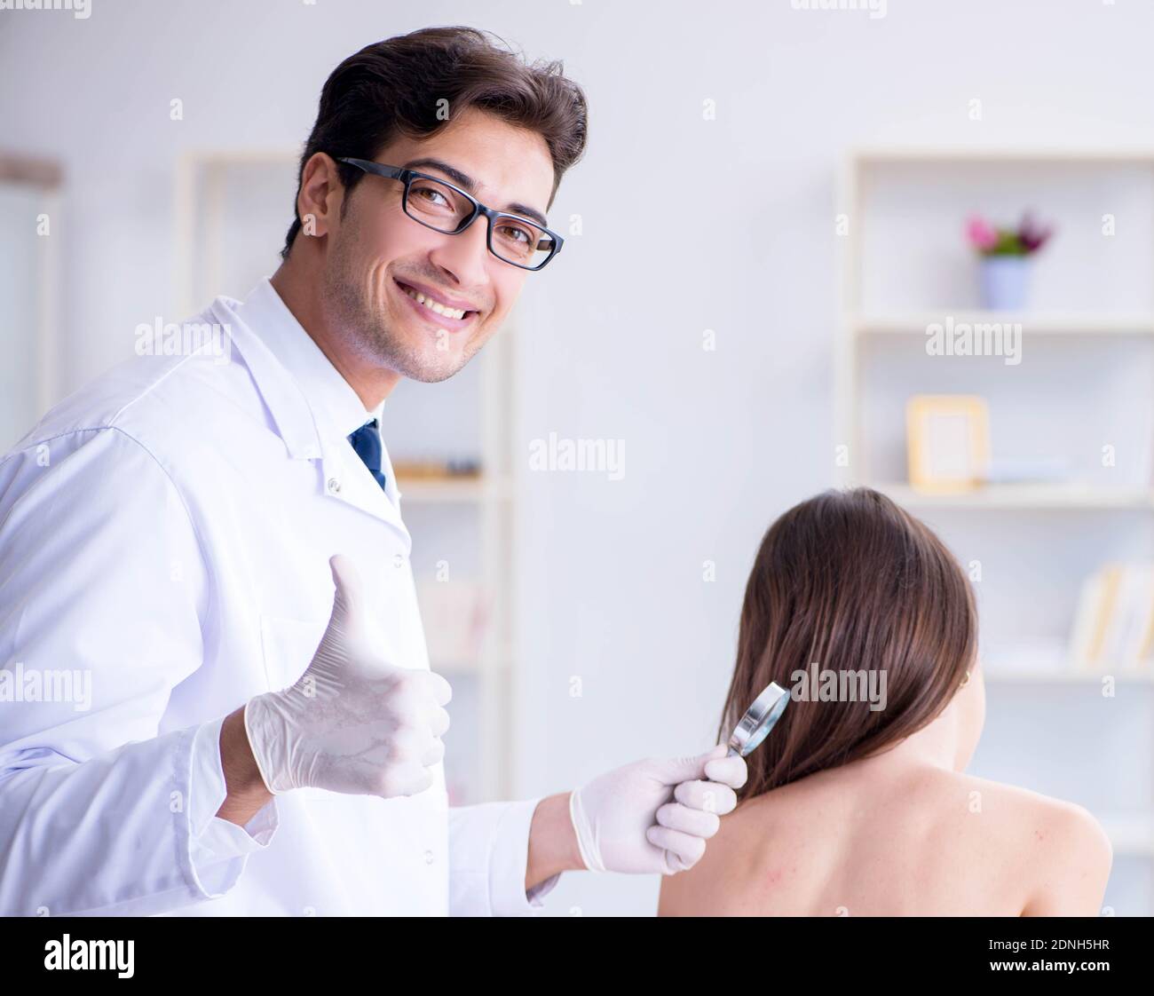 The doctor examining the skin of female patient Stock Photo - Alamy