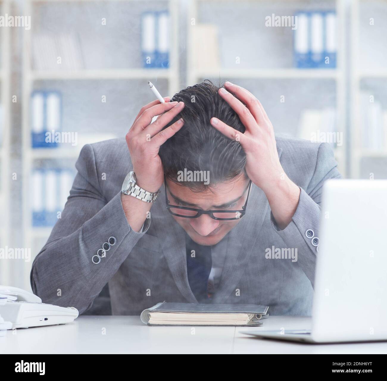 The businessman smoking in office at work Stock Photo - Alamy