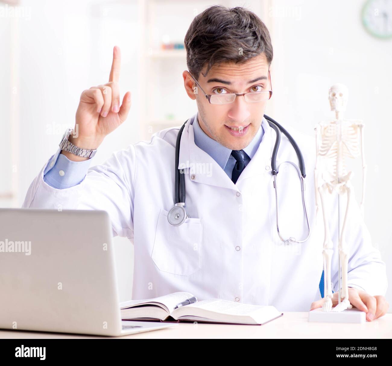 The doctor explaining human body on skeleton Stock Photo - Alamy