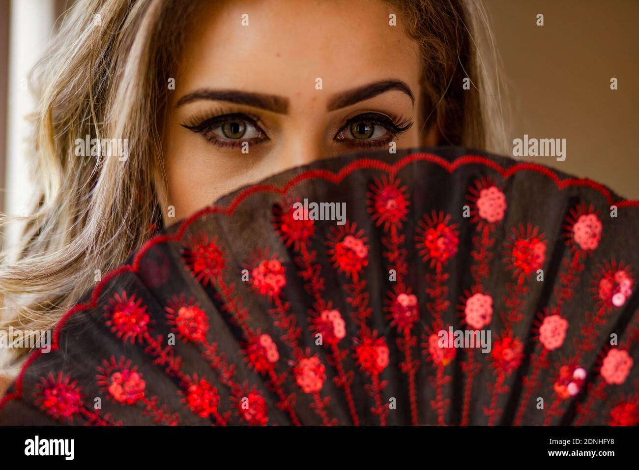 Woman covering face hand fan hi-res stock photography and images - Alamy